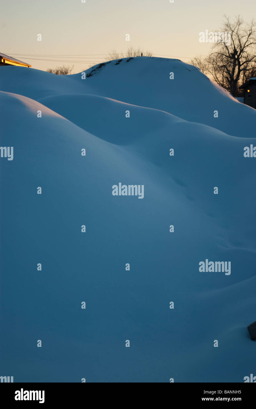 The sun sets over smooth mounds of snow Stock Photo - Alamy