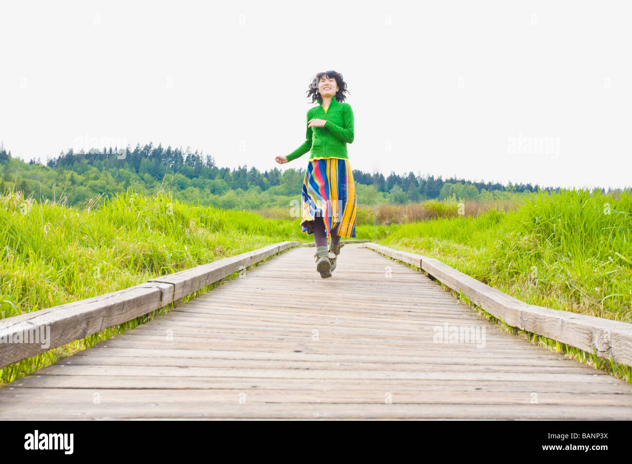 Carefree woman running on path hi-res stock photography and images - Alamy
