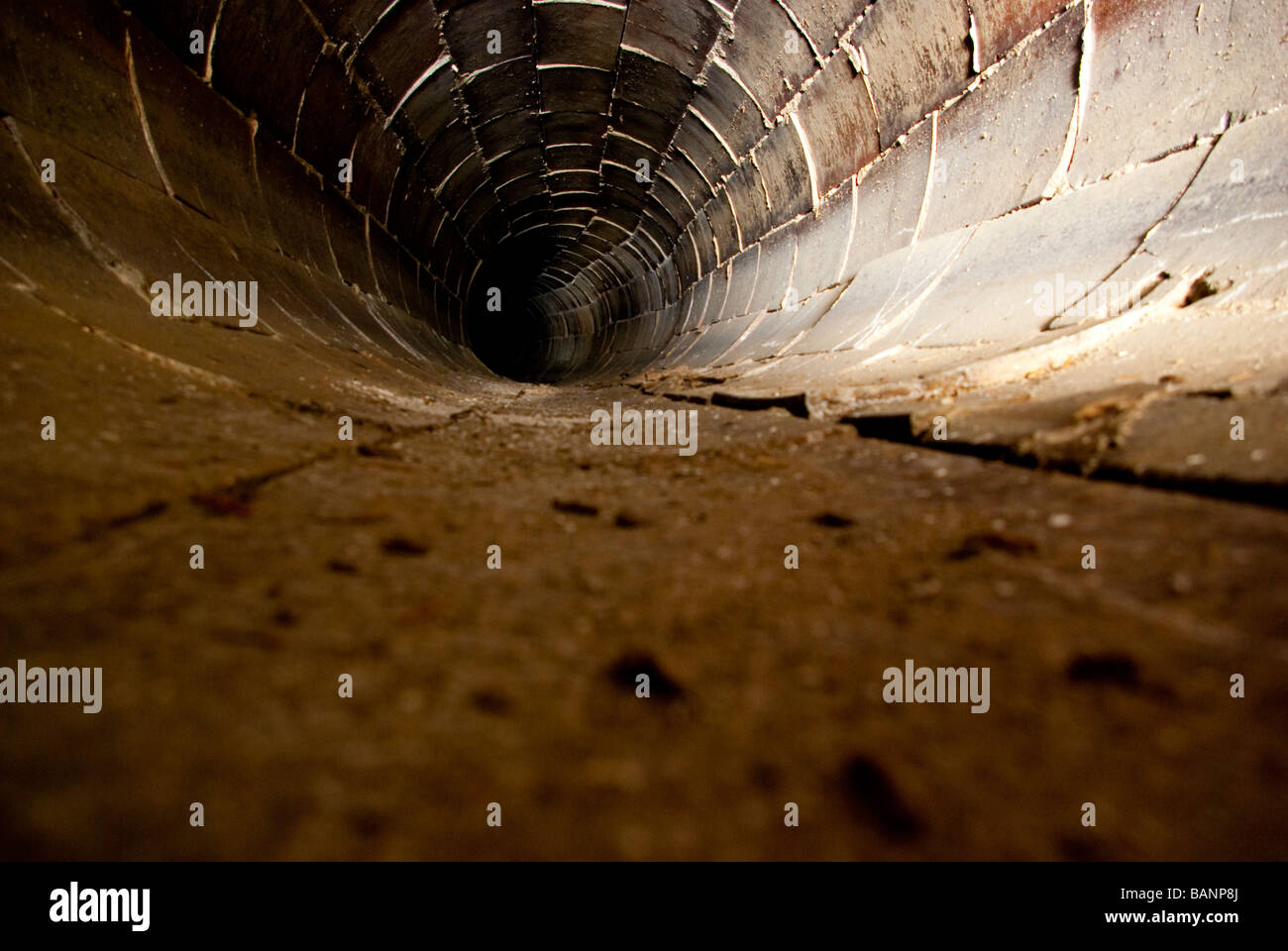 Looking down an old red brick storm drain from inside Stock Photo - Alamy