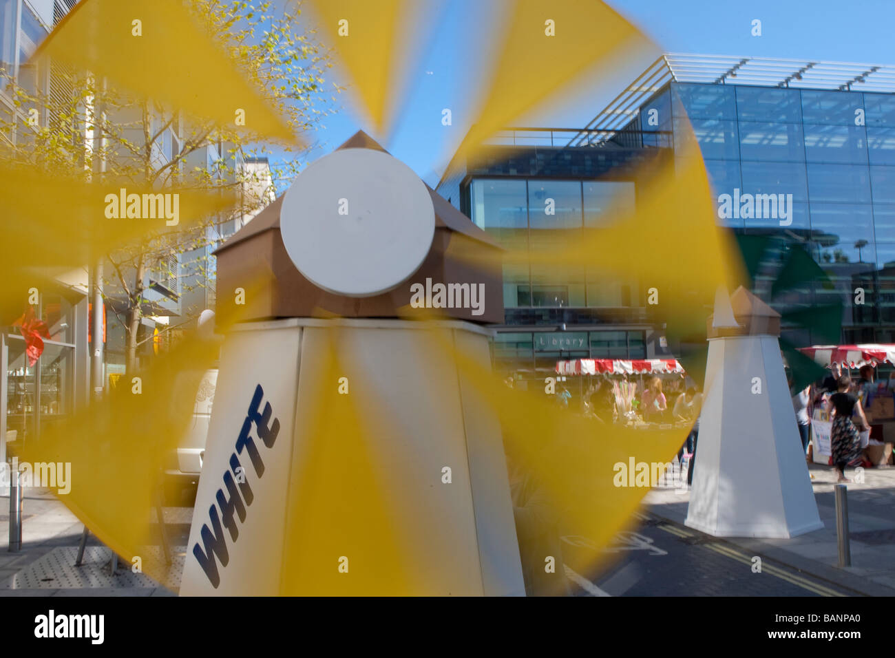 Yellow blades of paper windmill in sunlight during festival. Brighton ...