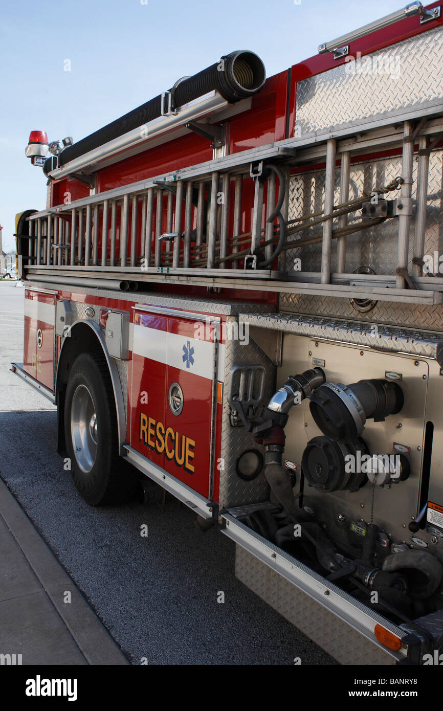 American red fire rescue truck with ladder parked in the city street ...