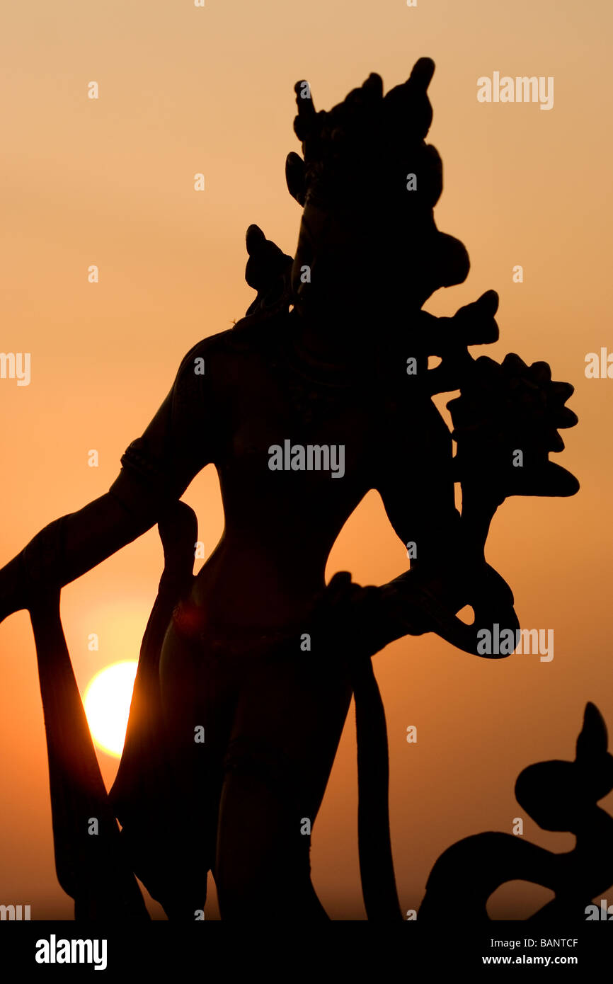 Statue of Buddhist Goddess Tara against Spectacular Sunset Sky Stock ...