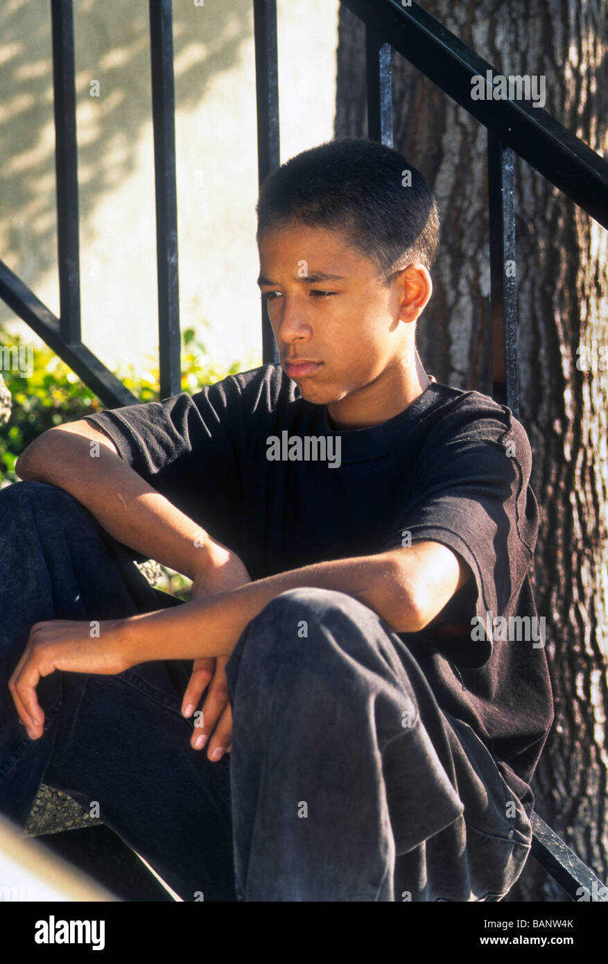 Serious teen boy think ponder consider thought meditate sad unhappy ...