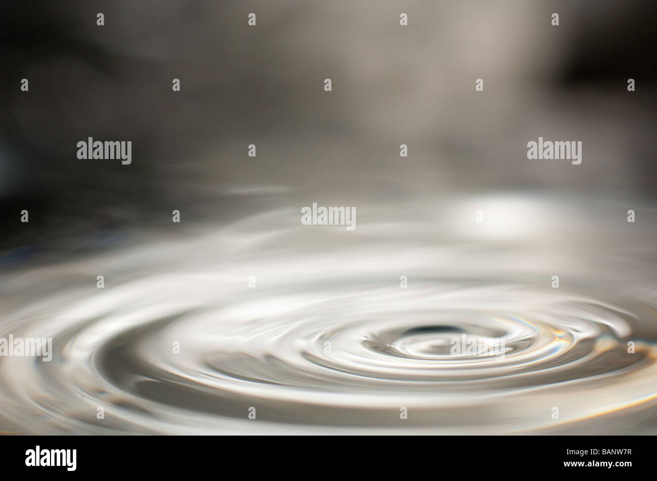 Droplet causing ripples on surface of a pool of water Stock Photo - Alamy