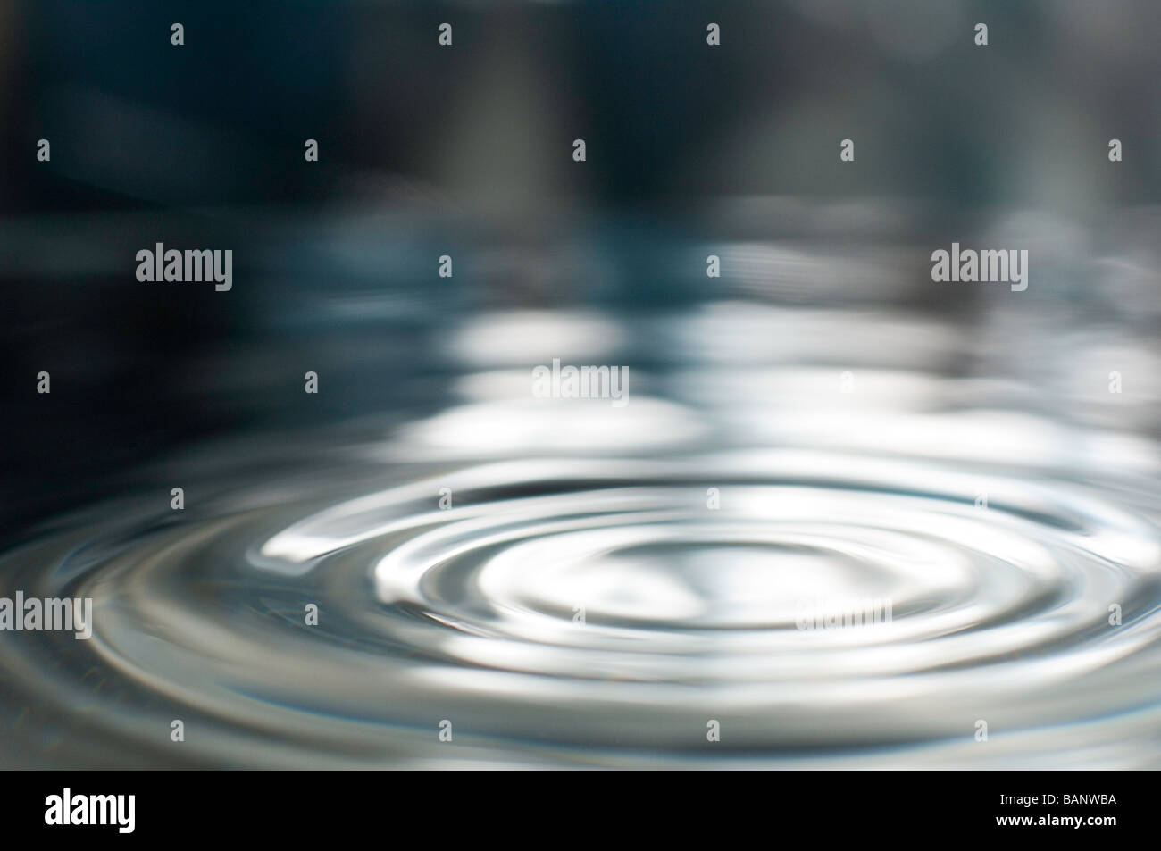 Droplet causing ripples on surface of a pool of water Stock Photo - Alamy