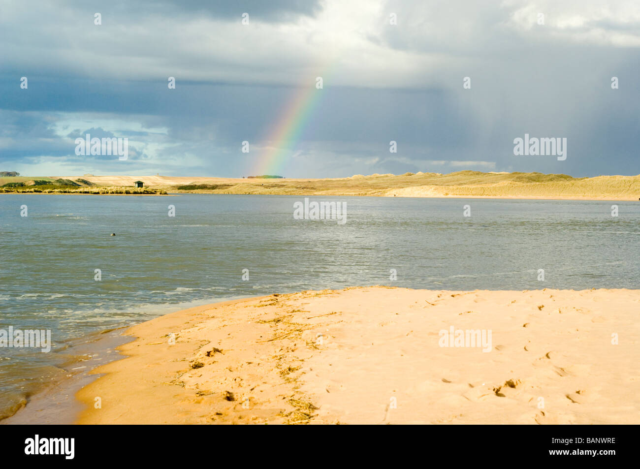 Rainbow and storm clouds over the Sands of Forvie sand dunes, viewed ...