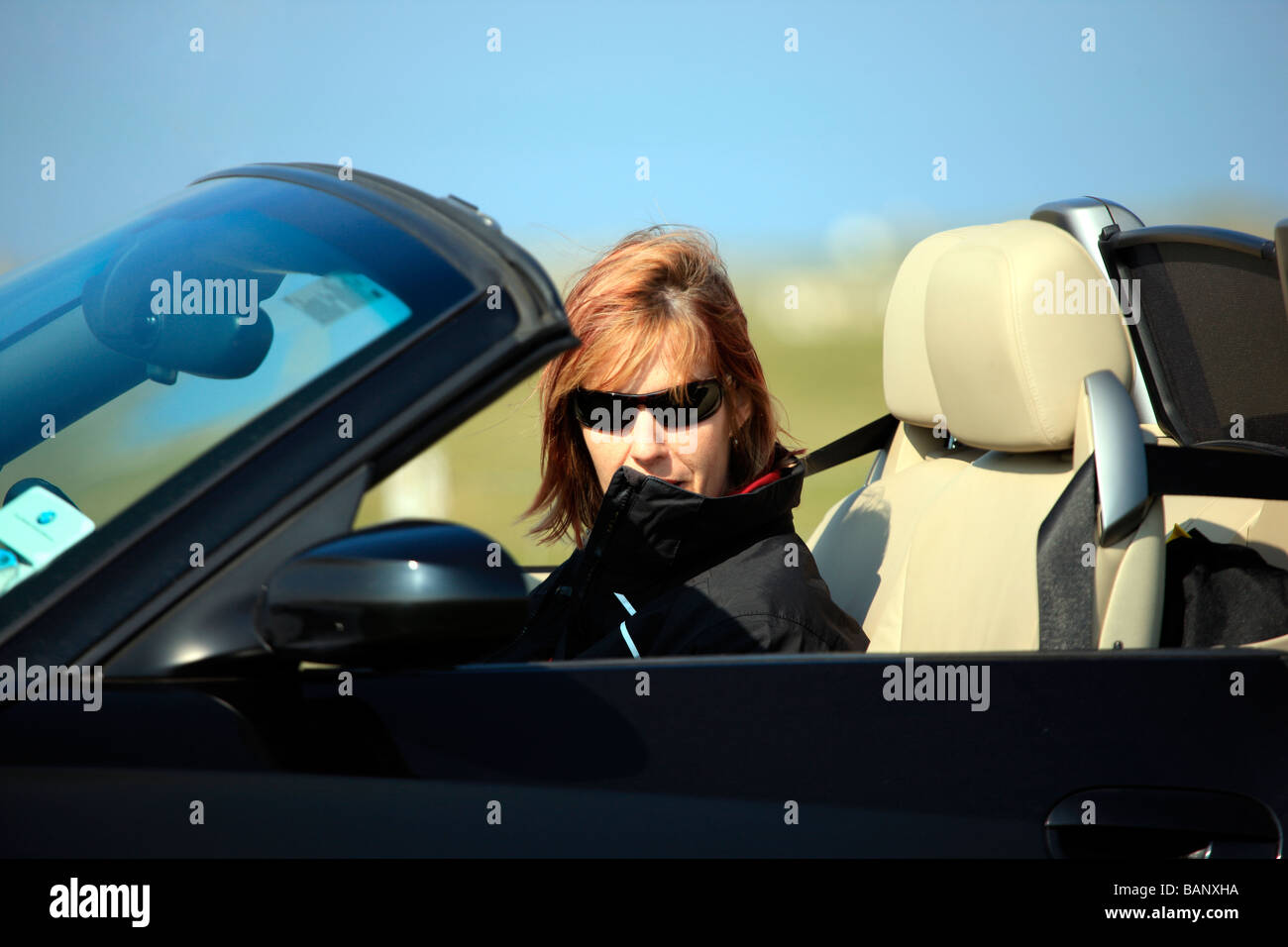 Attractive woman with sunglasses in soft top convertible car Stock ...
