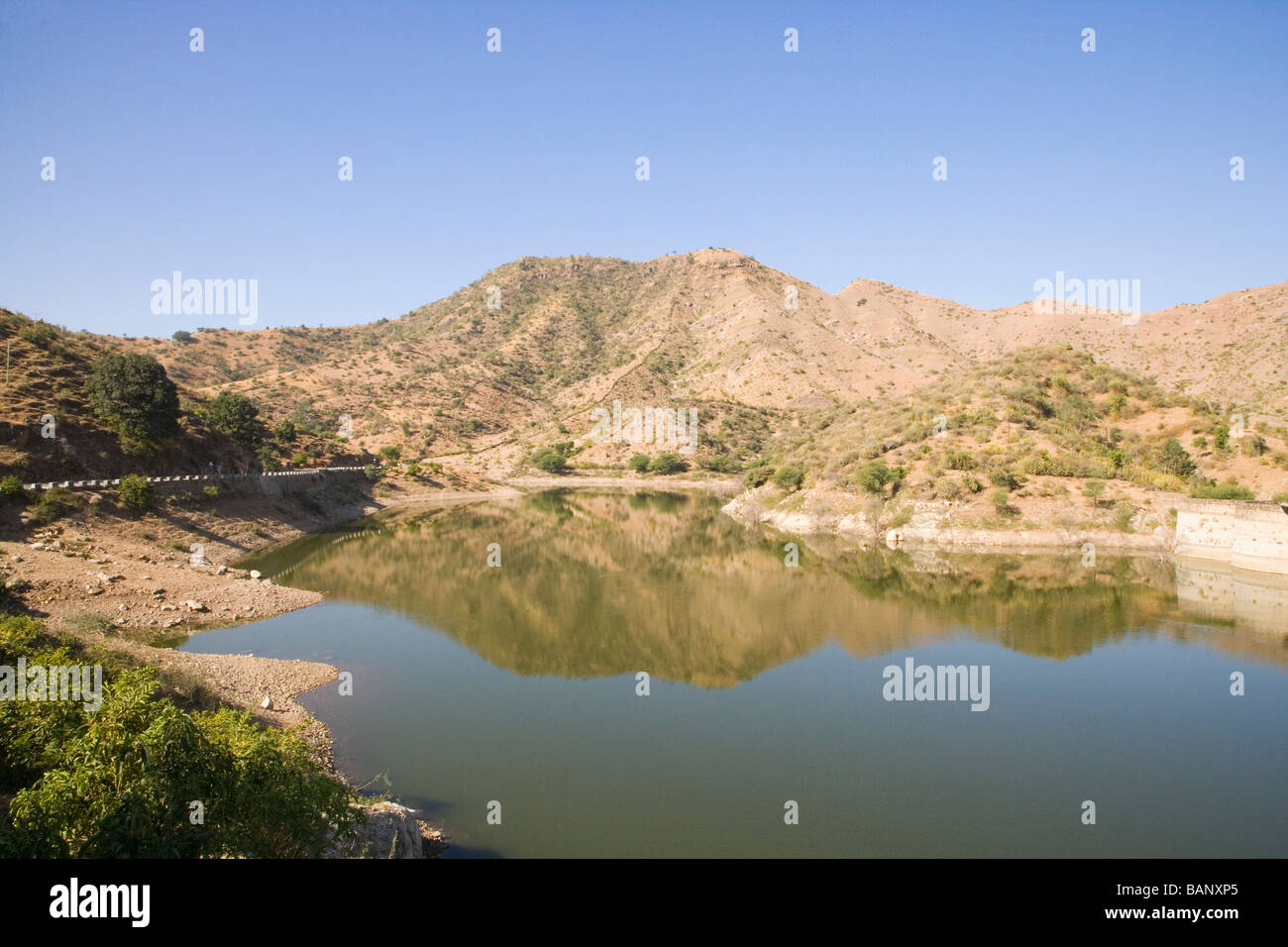Reflection of mountain in a lake, Udaipur, Rajasthan, India Stock Photo ...