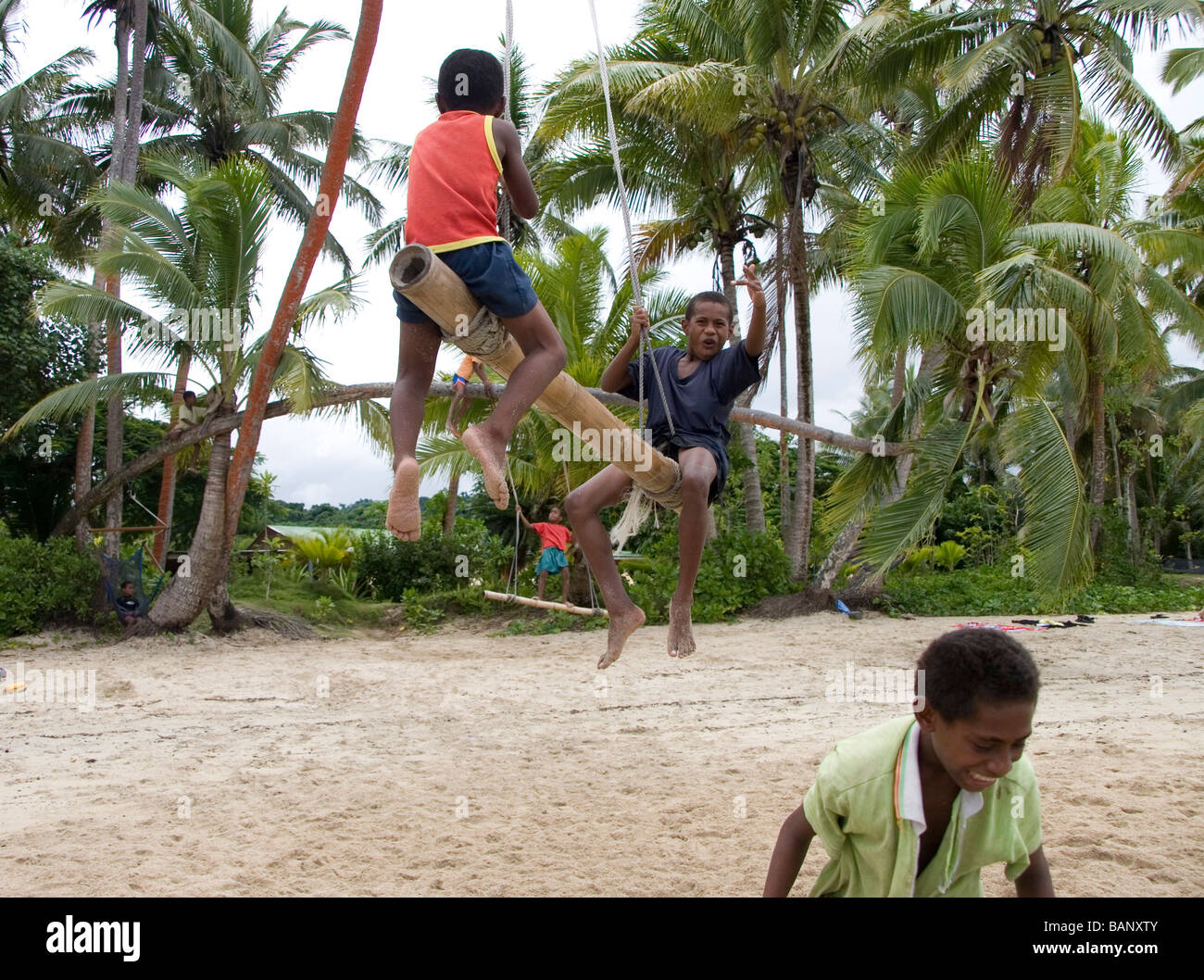 Fijian boys on swings playing Stock Photo - Alamy