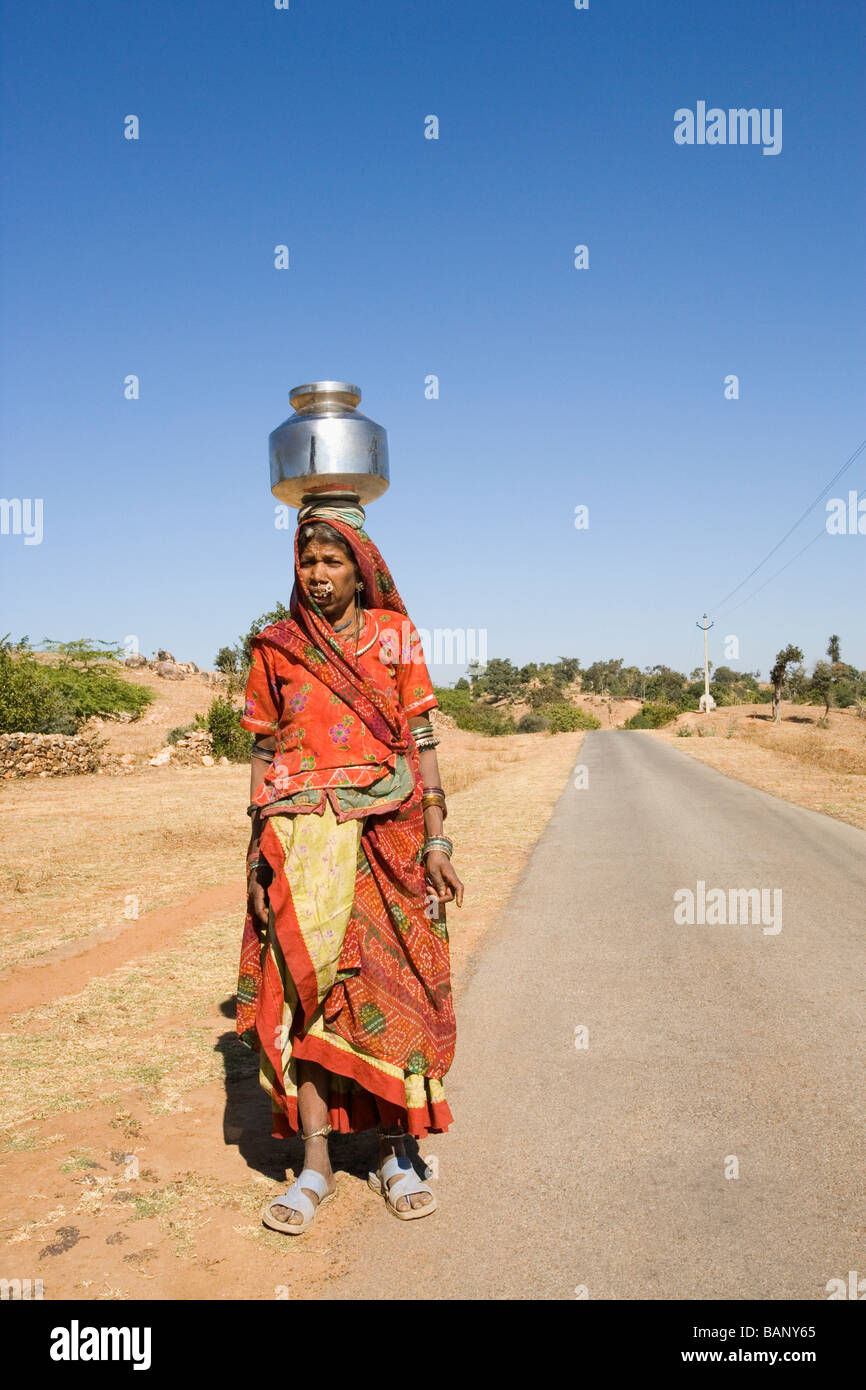 Woman carrying brass pot on her head, Udaipur, Rajasthan, India Stock ...
