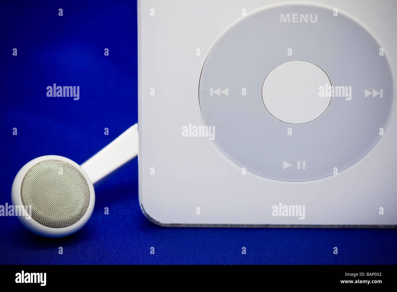 Crop of a Ipod player showing the control wheel and a earphone Stock ...