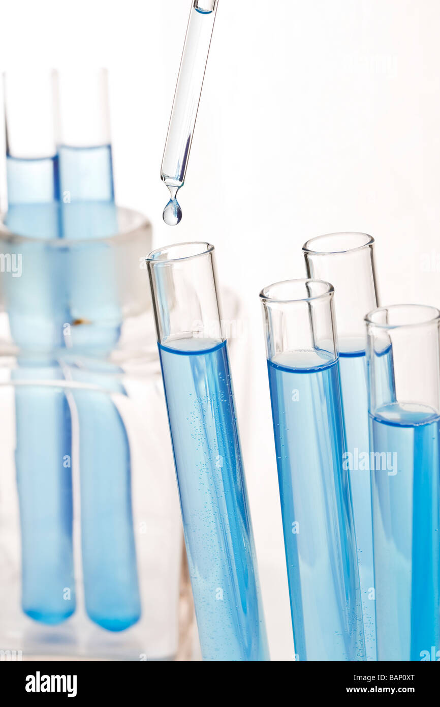 Blue chemical in laboratory testing tubes White background Stock Photo ...
