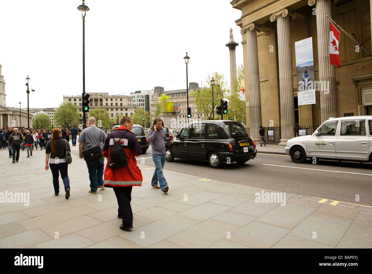people walking along street in Pall Mall heading towards Trafalgar Sq ...