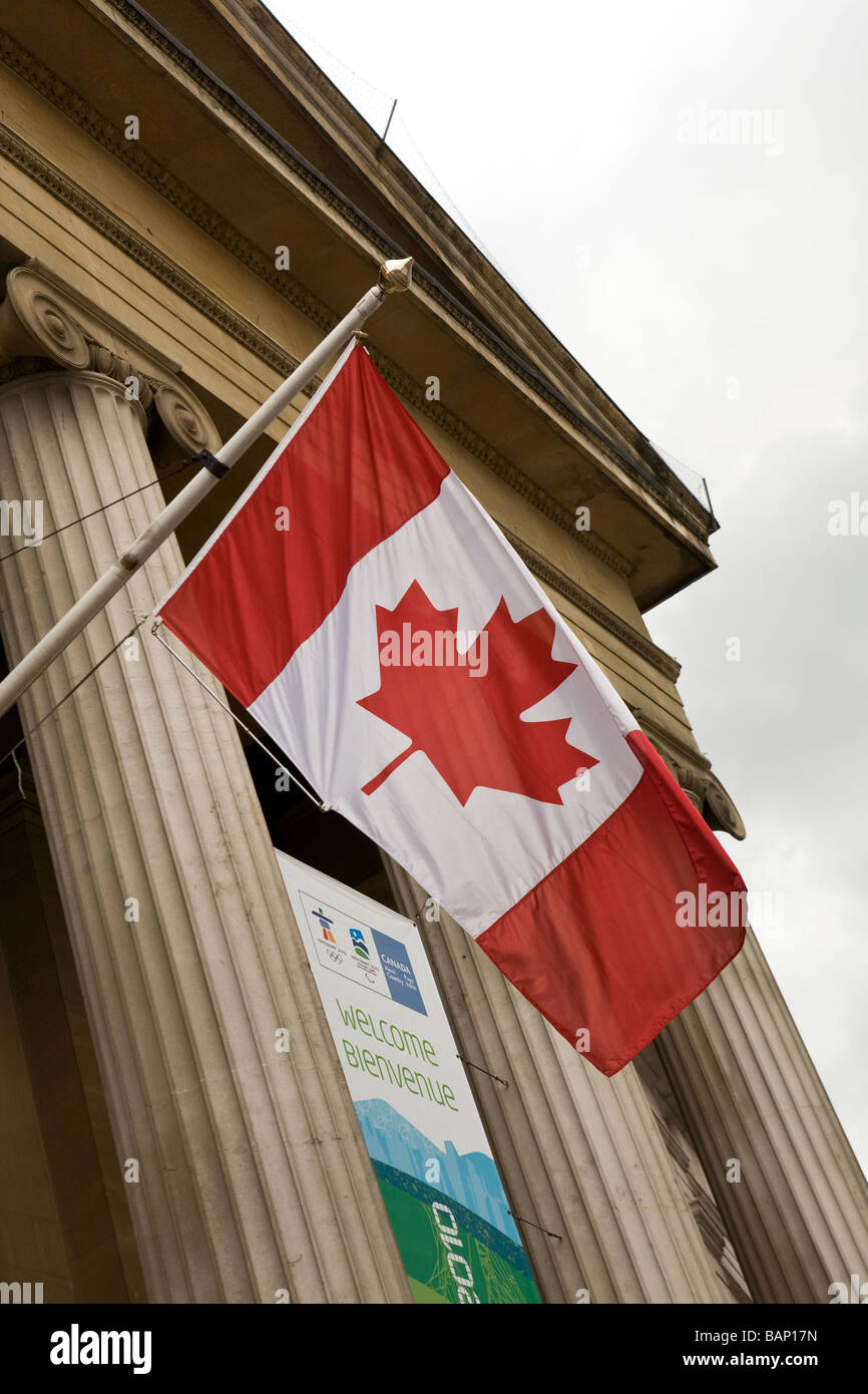 Canadian flag hanging from a historic London building with tall columns ...