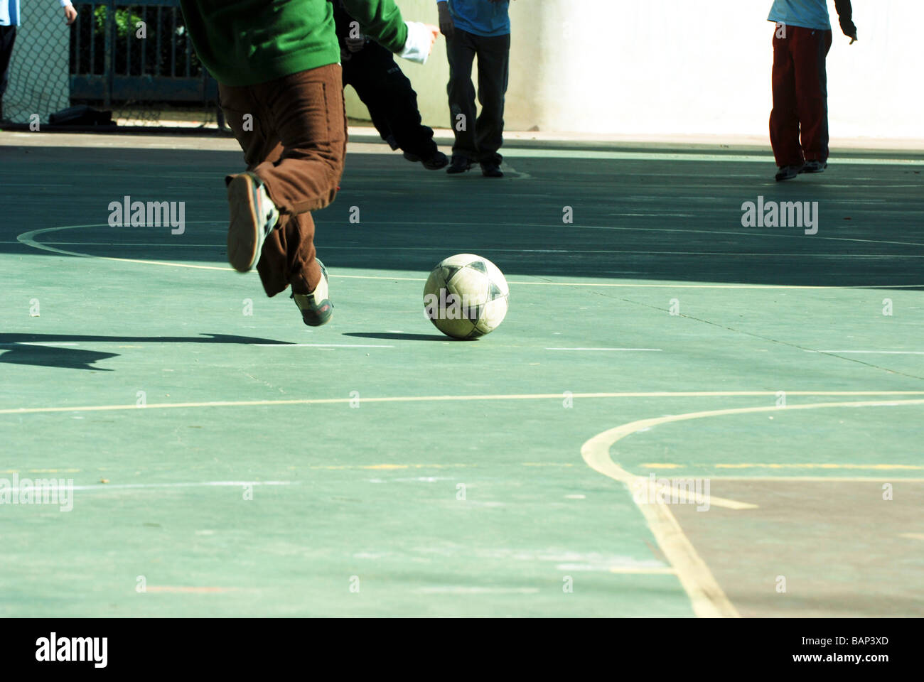 Children playing soccer in a school yard Stock Photo - Alamy