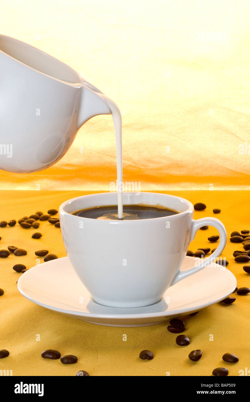 Coffee with cream on a gold background Stock Photo - Alamy