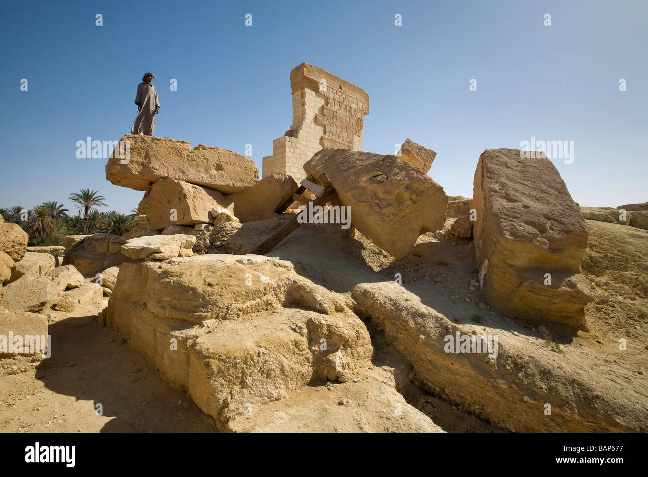 Siwa Oasis, Egypt; A local man stands on the Temple of Umm Ubayd Stock ...
