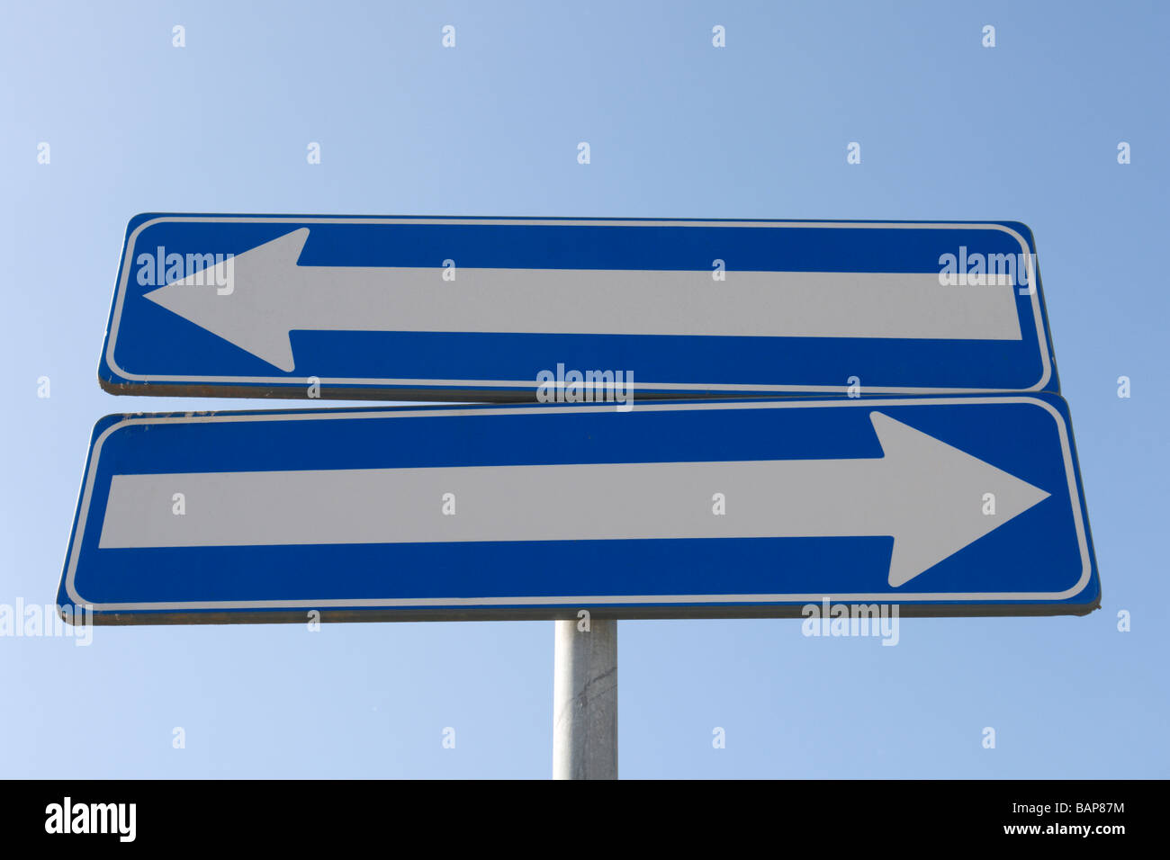 Road sign with two one way signs indicating opposite directions Stock ...