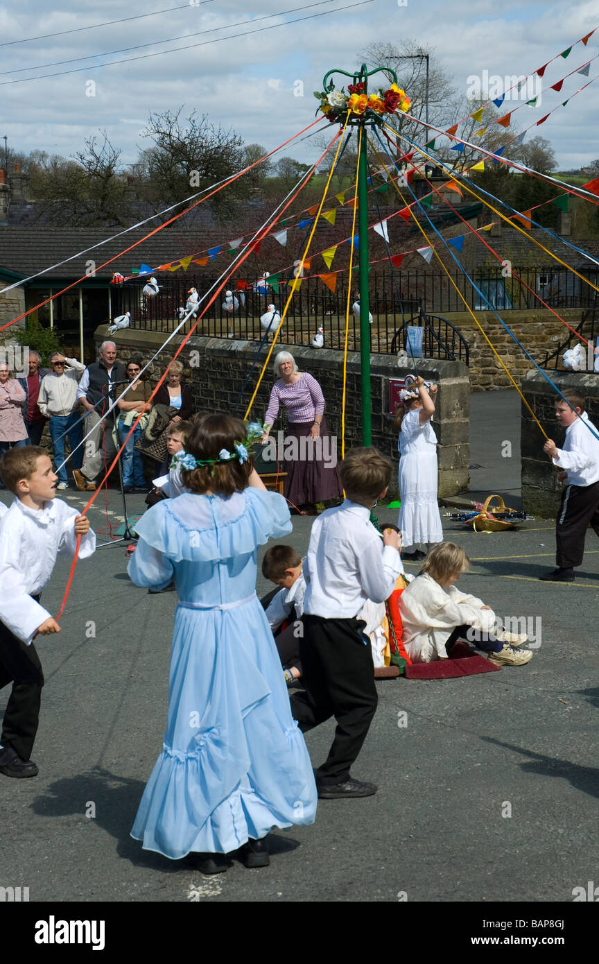 Children dancing around a maypole at the village of Wray, near ...