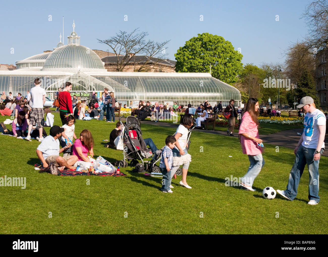 Groups of people enjoying a beautiful spring day on a lawn in front of ...