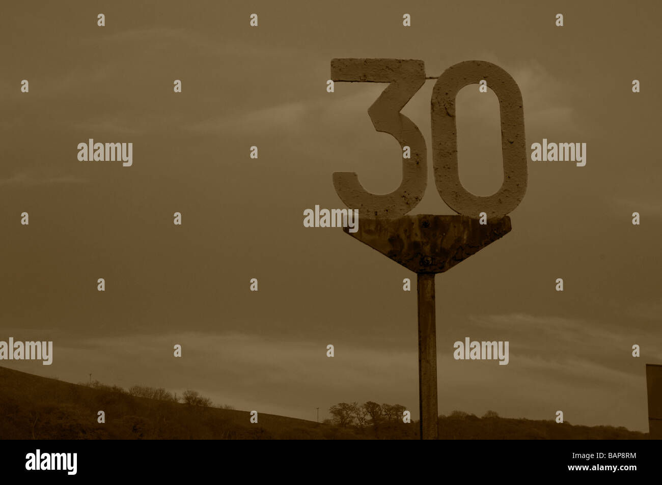 30 miles per hour speed sign black and white picture at a railway track ...