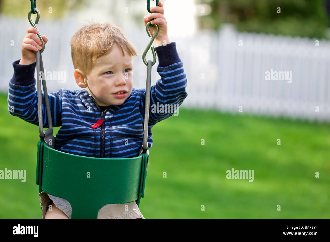 Boy on swing Stock Photo - Alamy