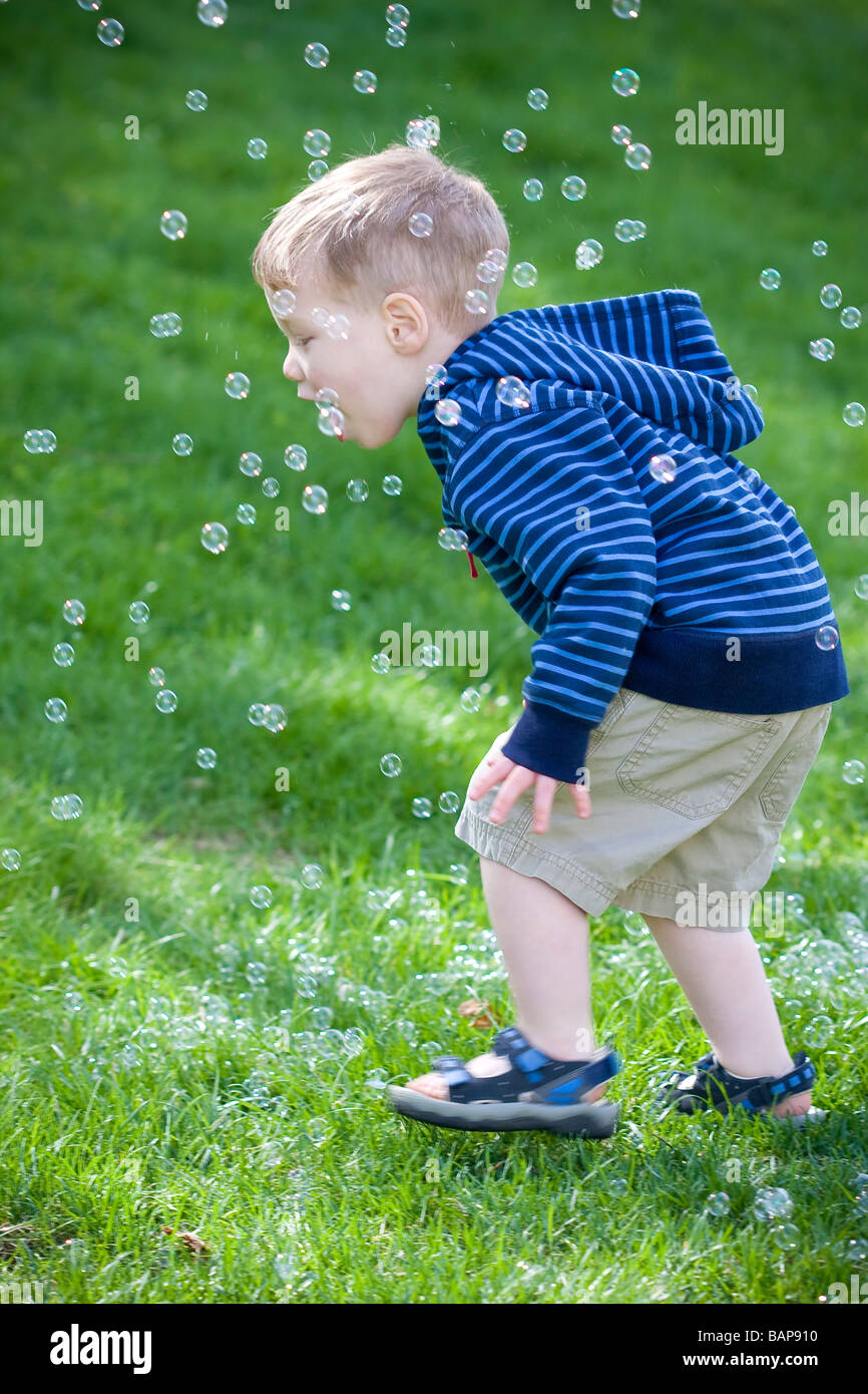 Boy chasing bubbles hi-res stock photography and images - Alamy