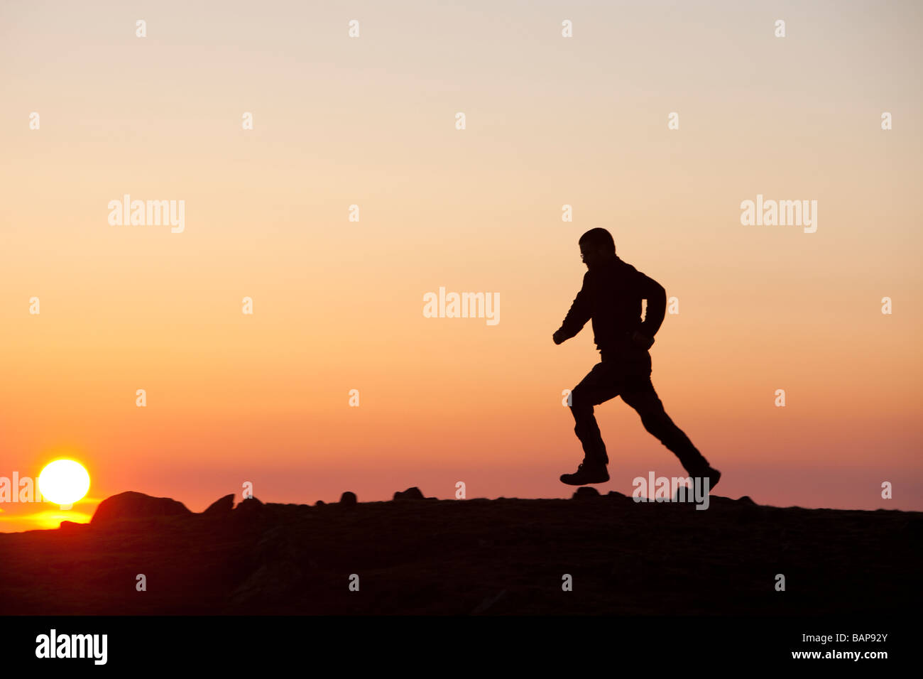 A man fell running on Red Screes at sunset in the Lake district ...