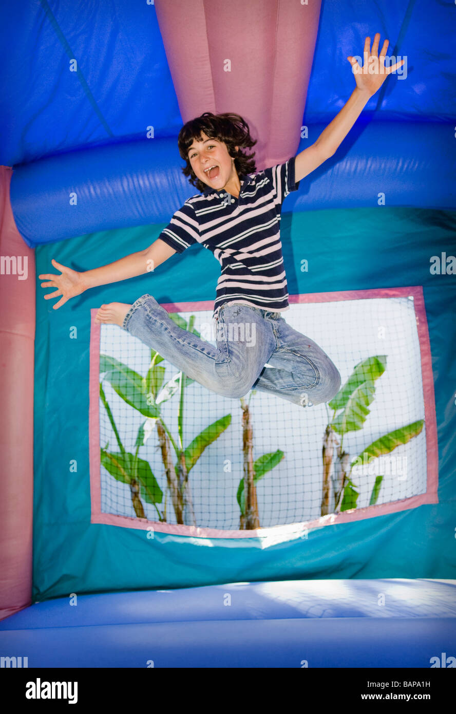 Boy jumping in jumper Stock Photo - Alamy