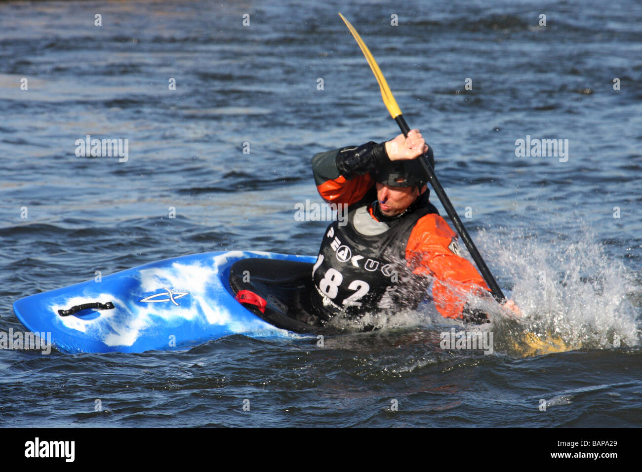 Canoeist paddles in fast water Stock Photo - Alamy
