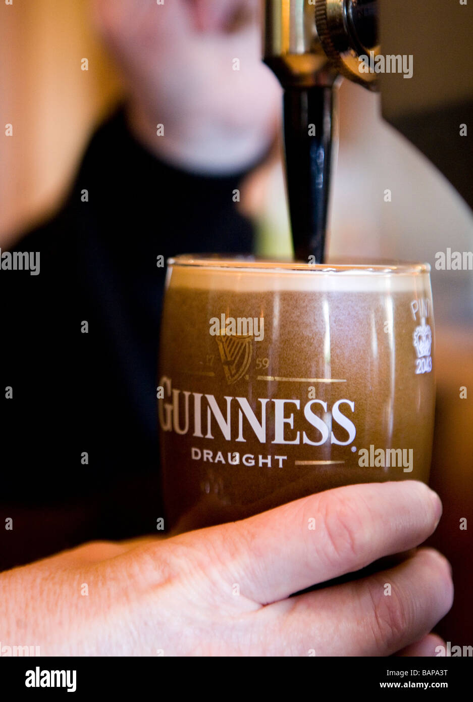 A pint of Guinness is poured at a pub Stock Photo - Alamy