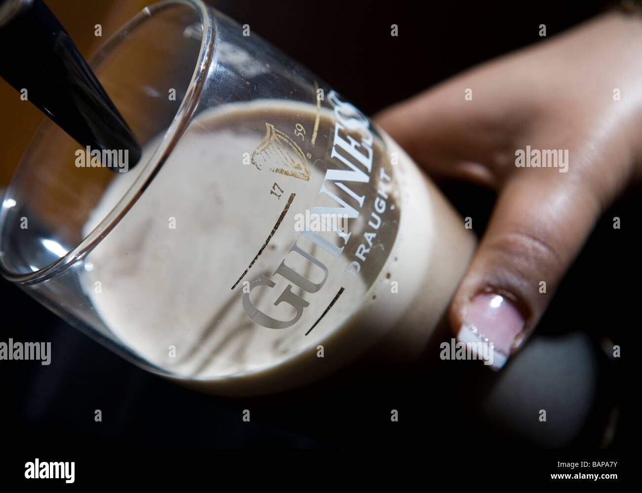 A pint of Guinness is poured at a pub Stock Photo - Alamy