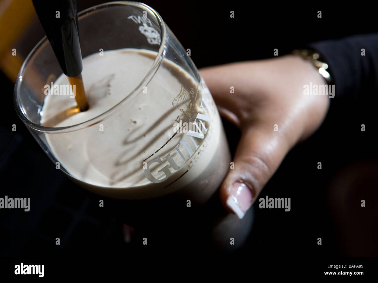 A pint of Guinness is poured at a pub Stock Photo - Alamy