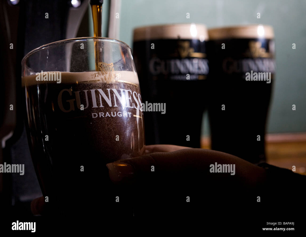 A pint of Guinness is poured at a pub Stock Photo - Alamy