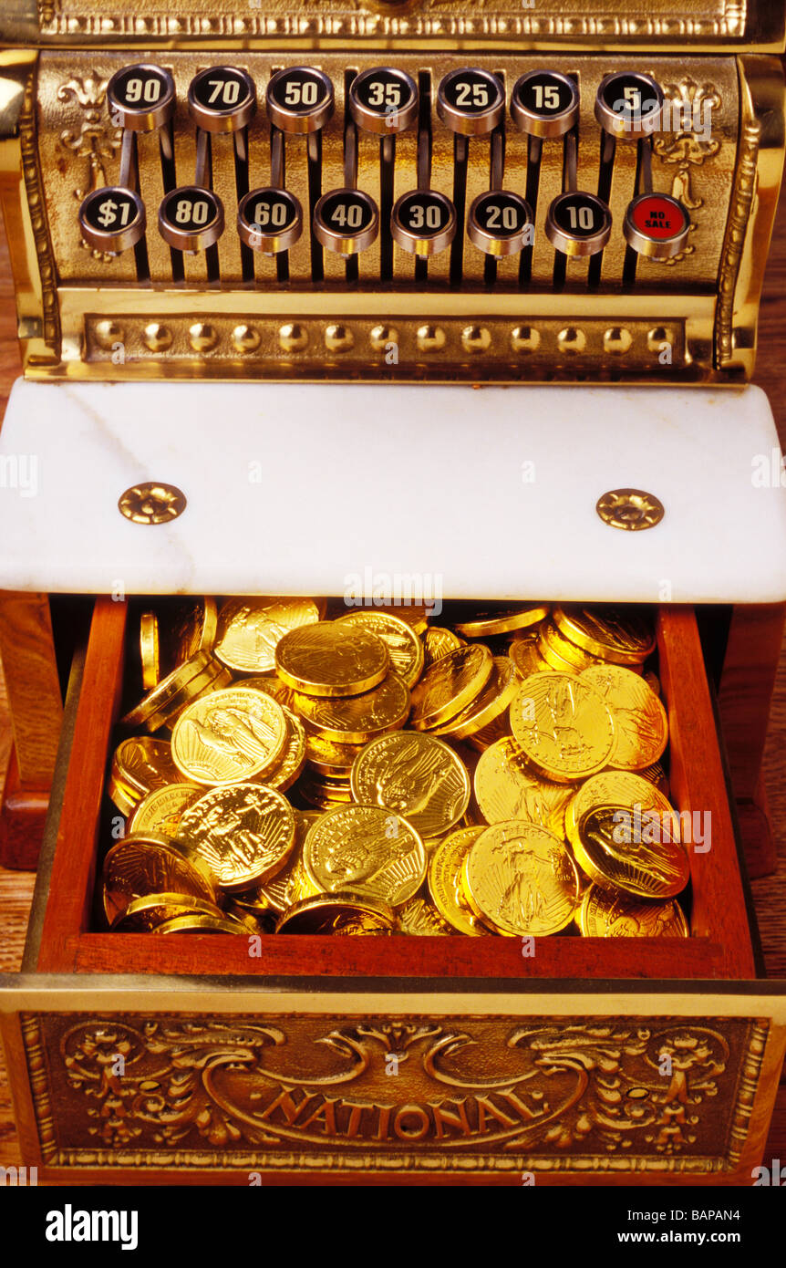 Old cash register with gold coins Stock Photo - Alamy