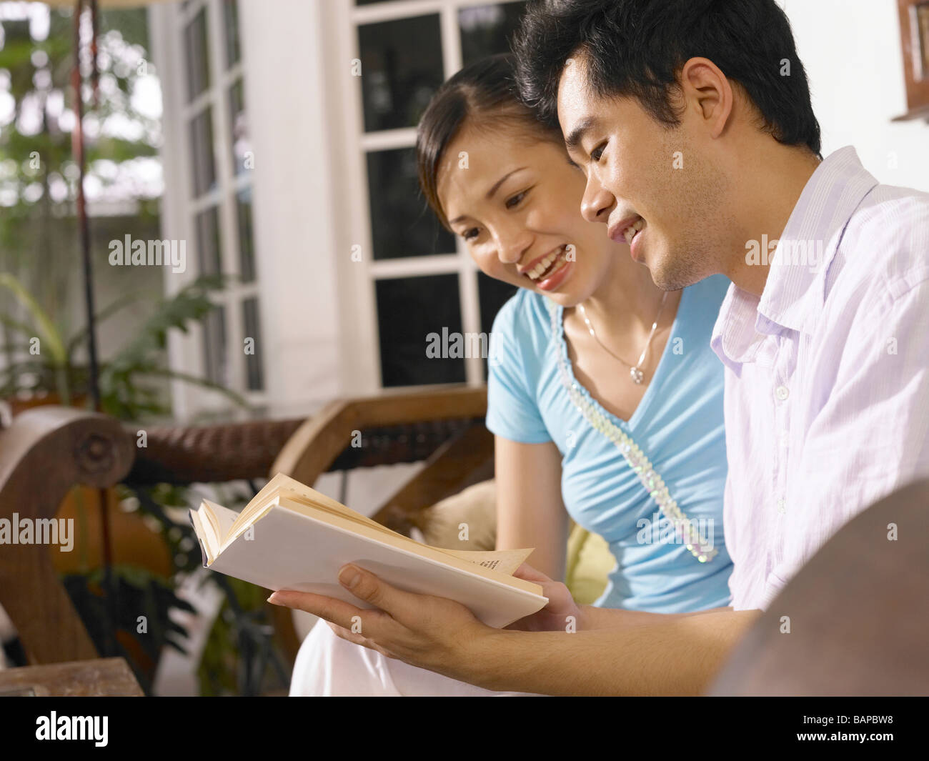 couple sharing reading book at the garden Stock Photo - Alamy