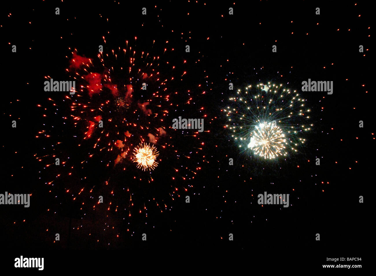 Star bursts of fireworks light up the night sky with assorted colors ...