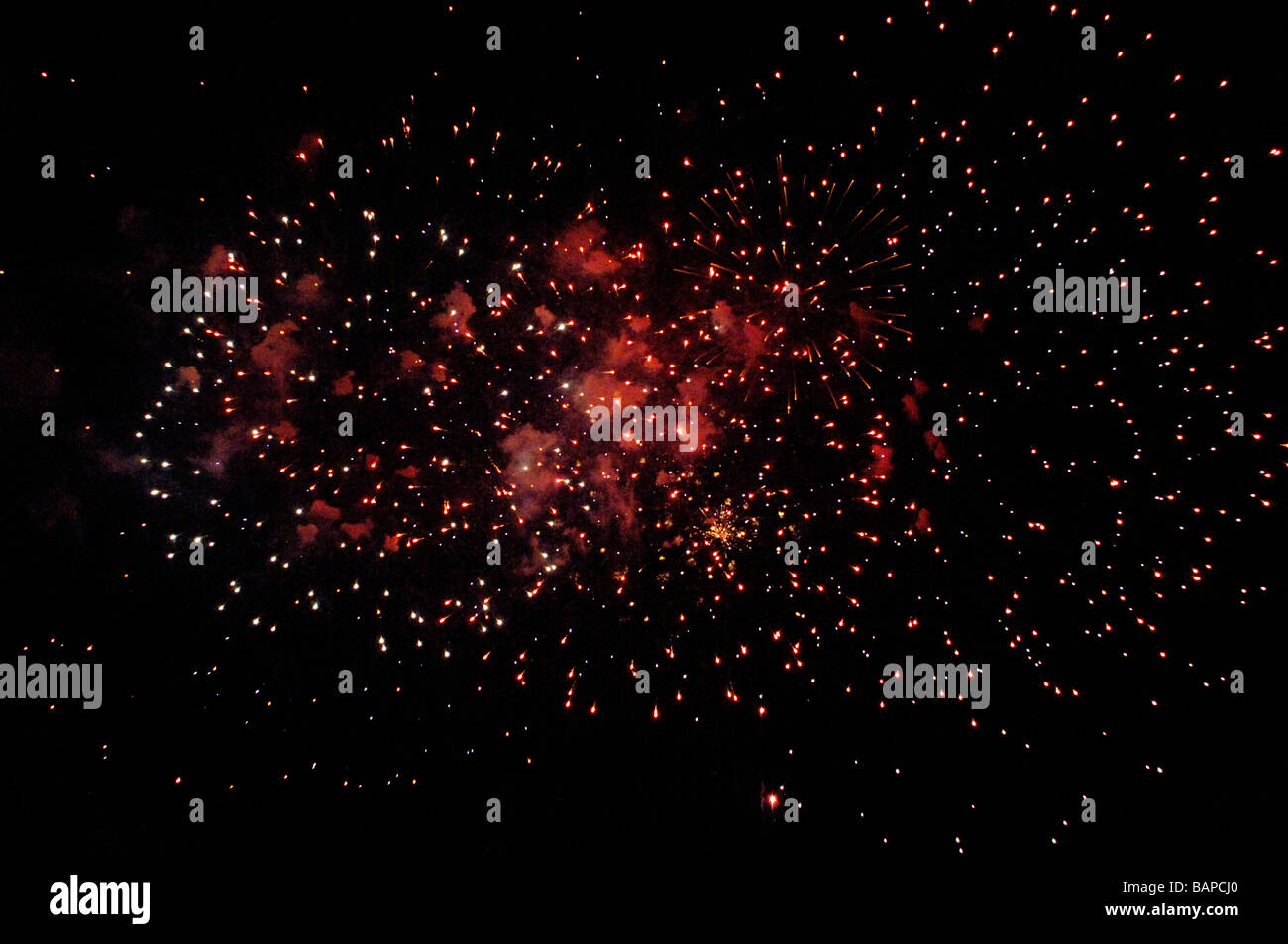 Star bursts of fireworks light up the night sky with assorted colors ...