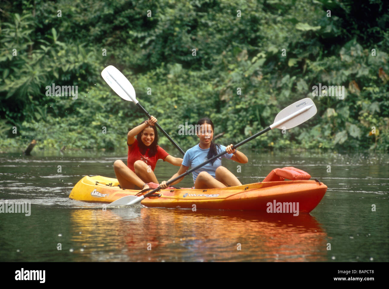 Girls paddling a kayak on river rainforest Costa Rica Stock Photo - Alamy