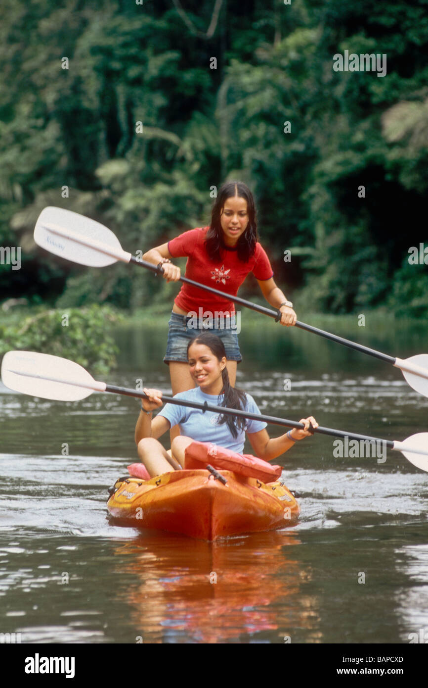 Girls paddling a kayak on river rainforest Costa Rica Stock Photo - Alamy
