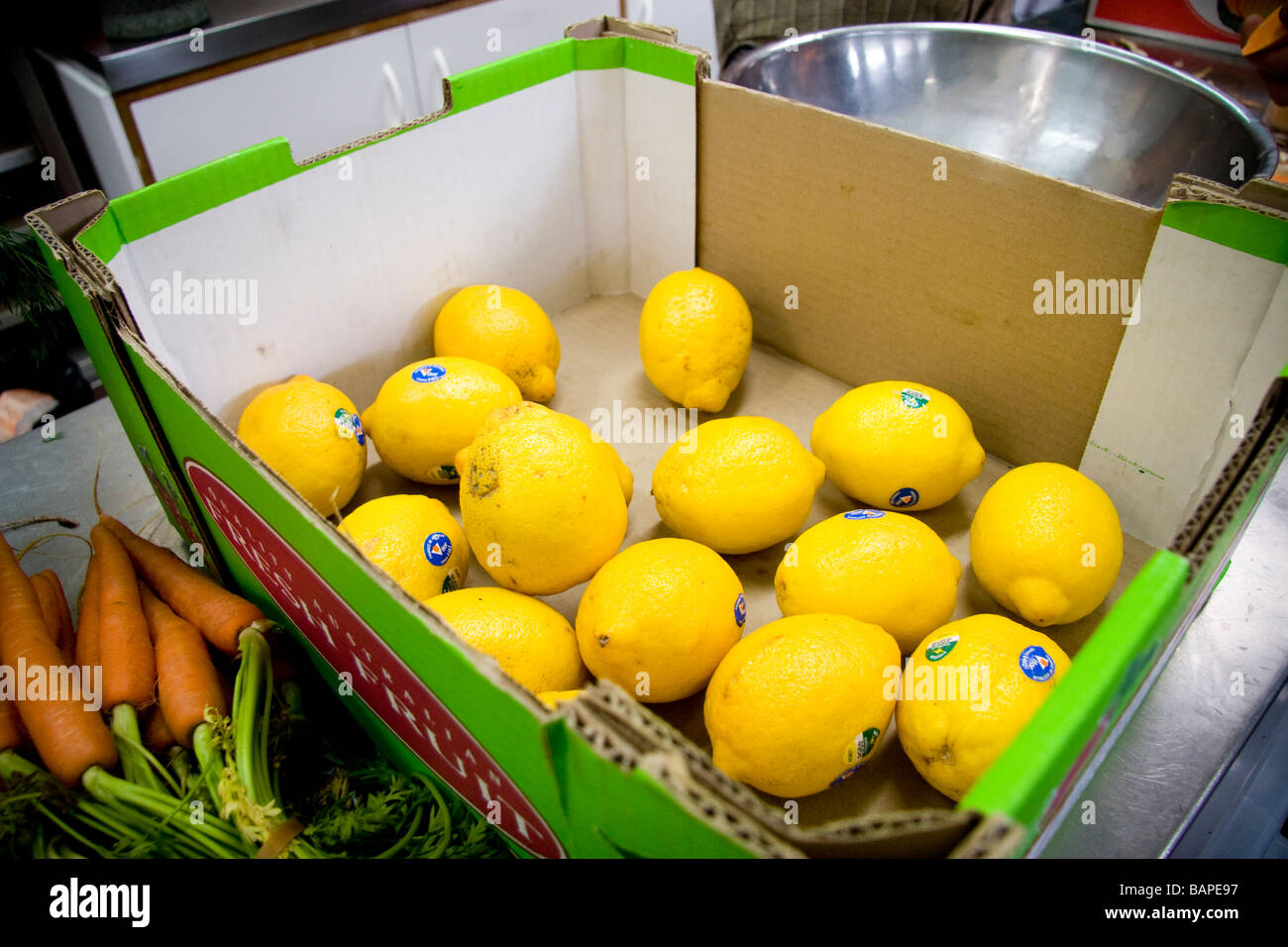 Box of lemons with carrots Stock Photo - Alamy