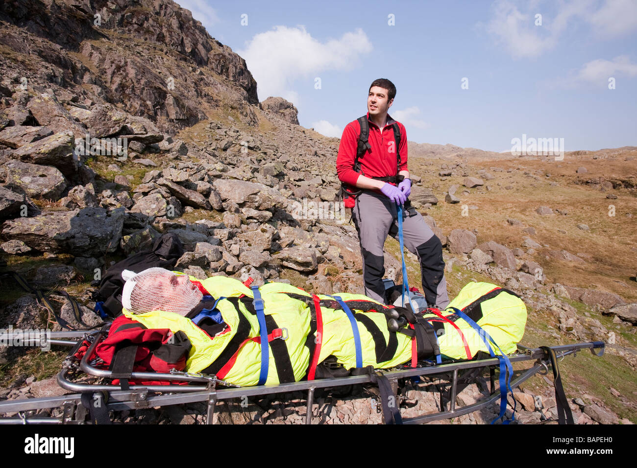 Members of the Langdale Ambleside mountain Rescue Team treat a man who ...