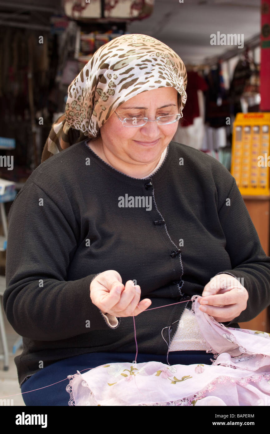Turkish woman in traditional scarf in Turkey sewing Stock Photo - Alamy