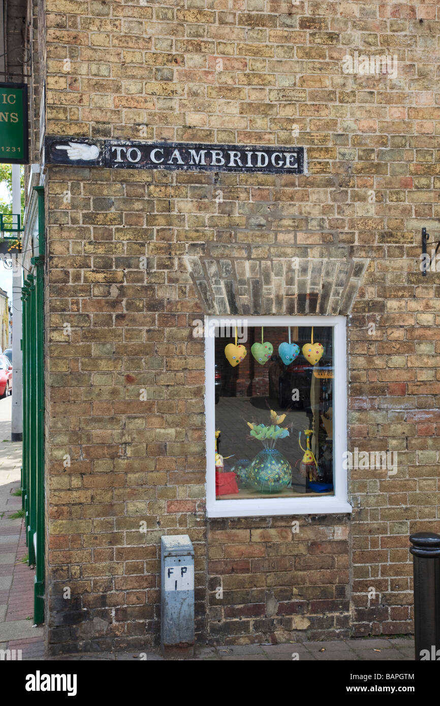 Historic road sign To Cambridge on a shop wall above a shop Window at ...