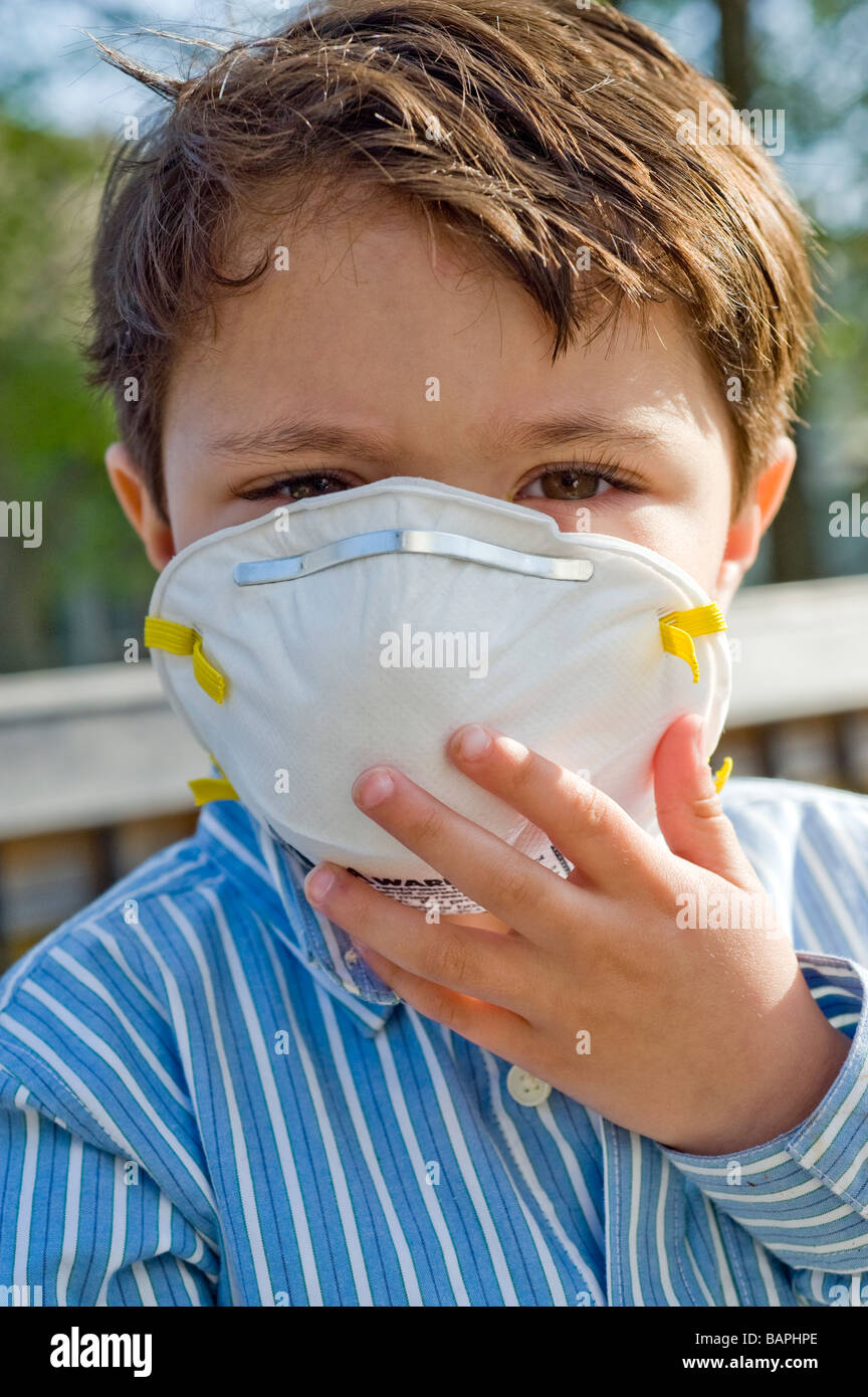 Three and 1/2 year old Hispanic boy wears a N95 rated respirator mask ...