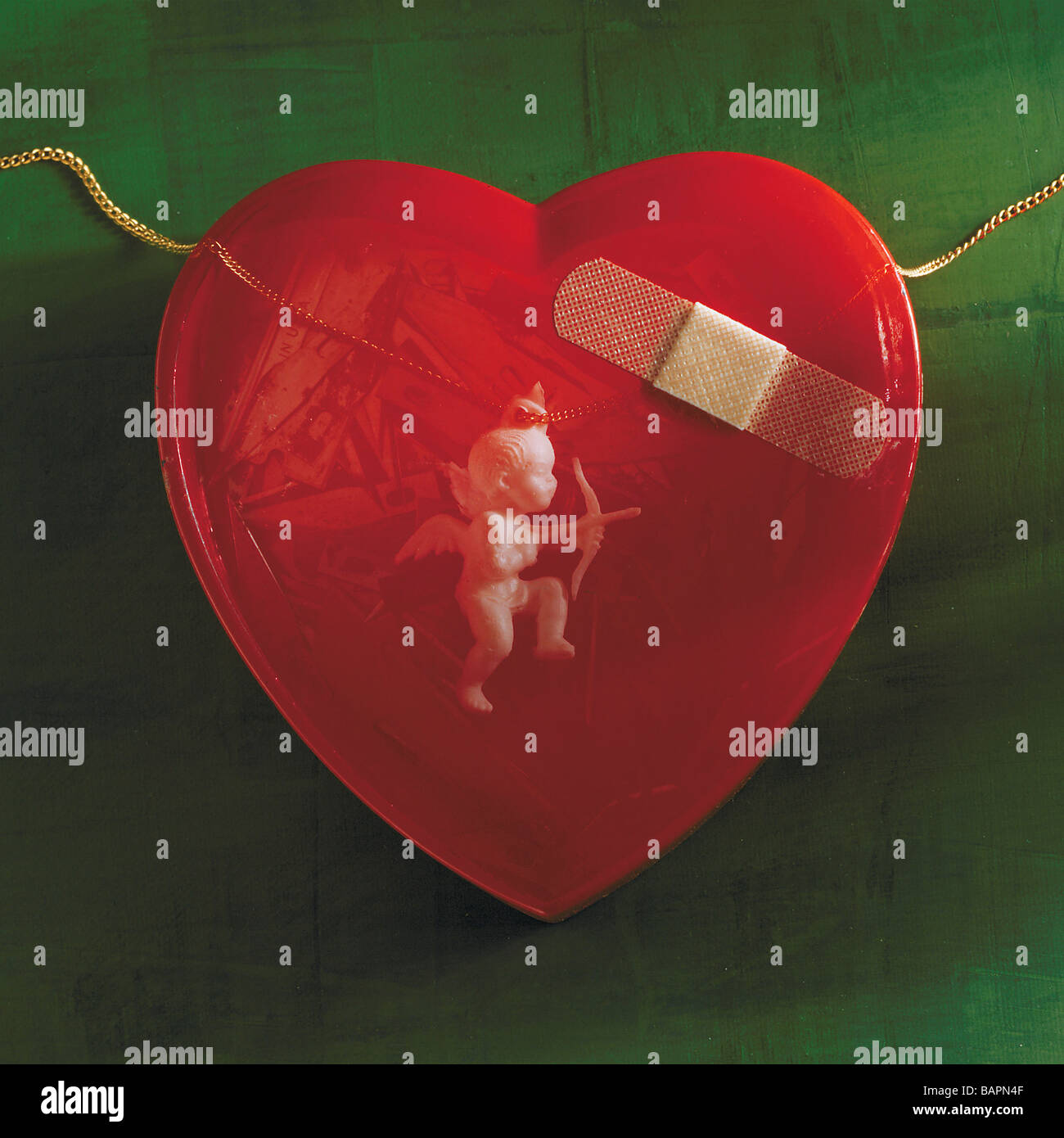 A red translucent heart shaped container with razor blades and a ...