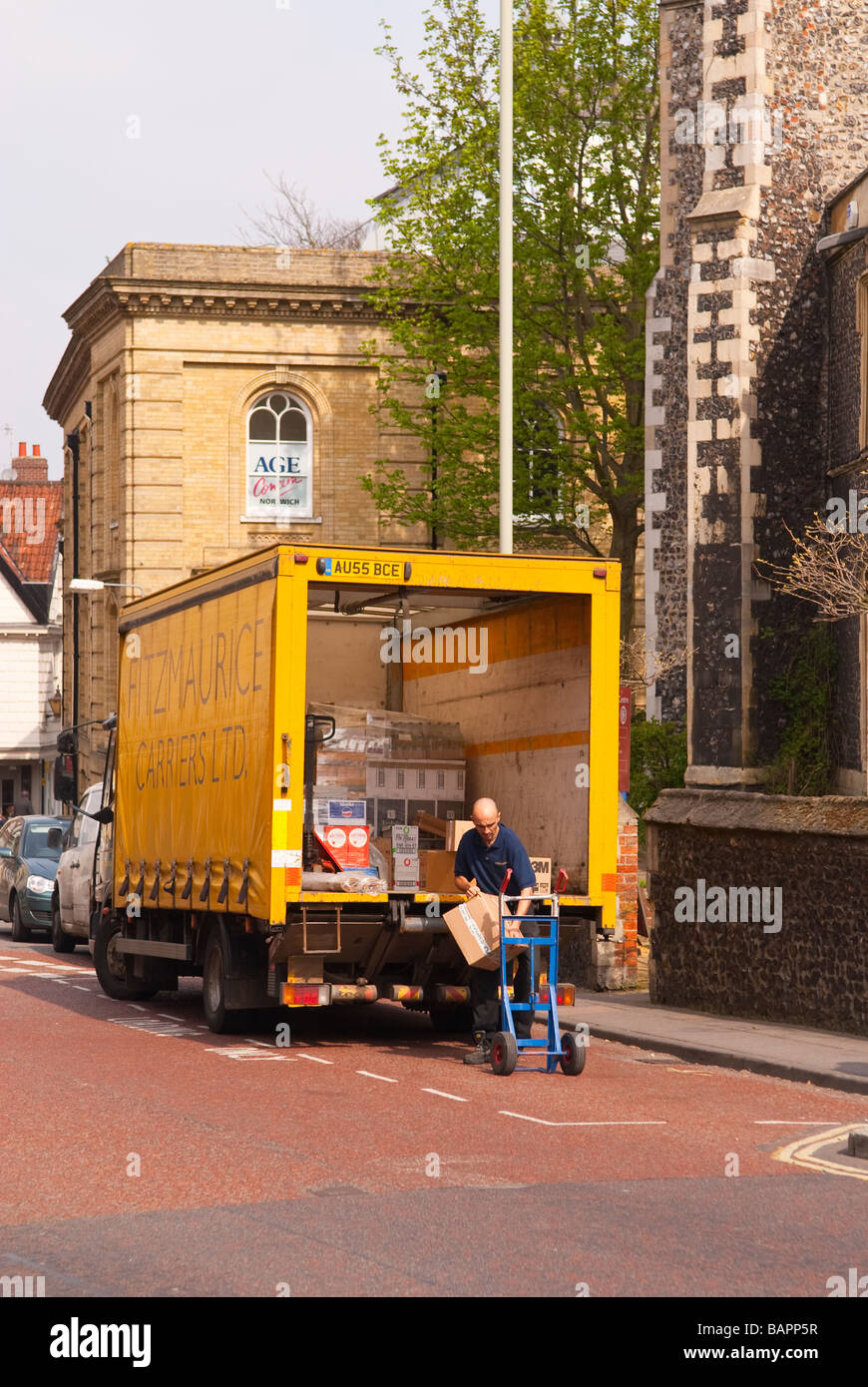 A courier unloading parcels from the back of a lorry in the uk Stock ...