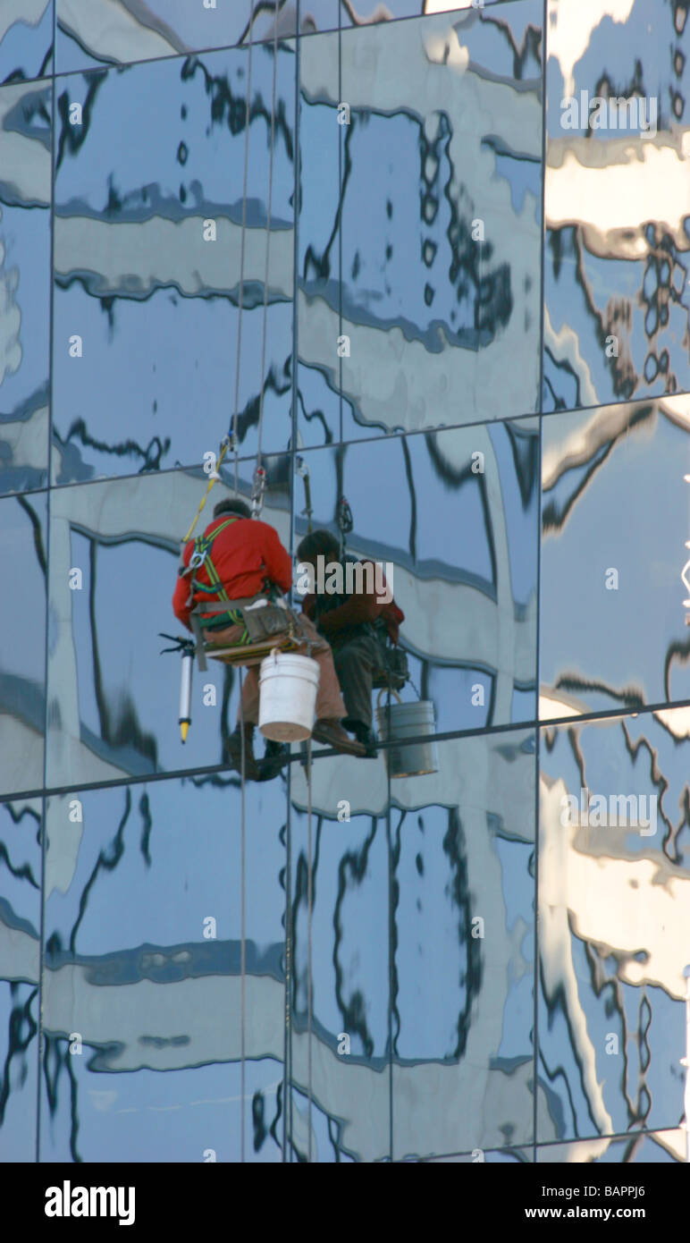Window washer hanging by a rope high up on skyscaper Stock Photo - Alamy