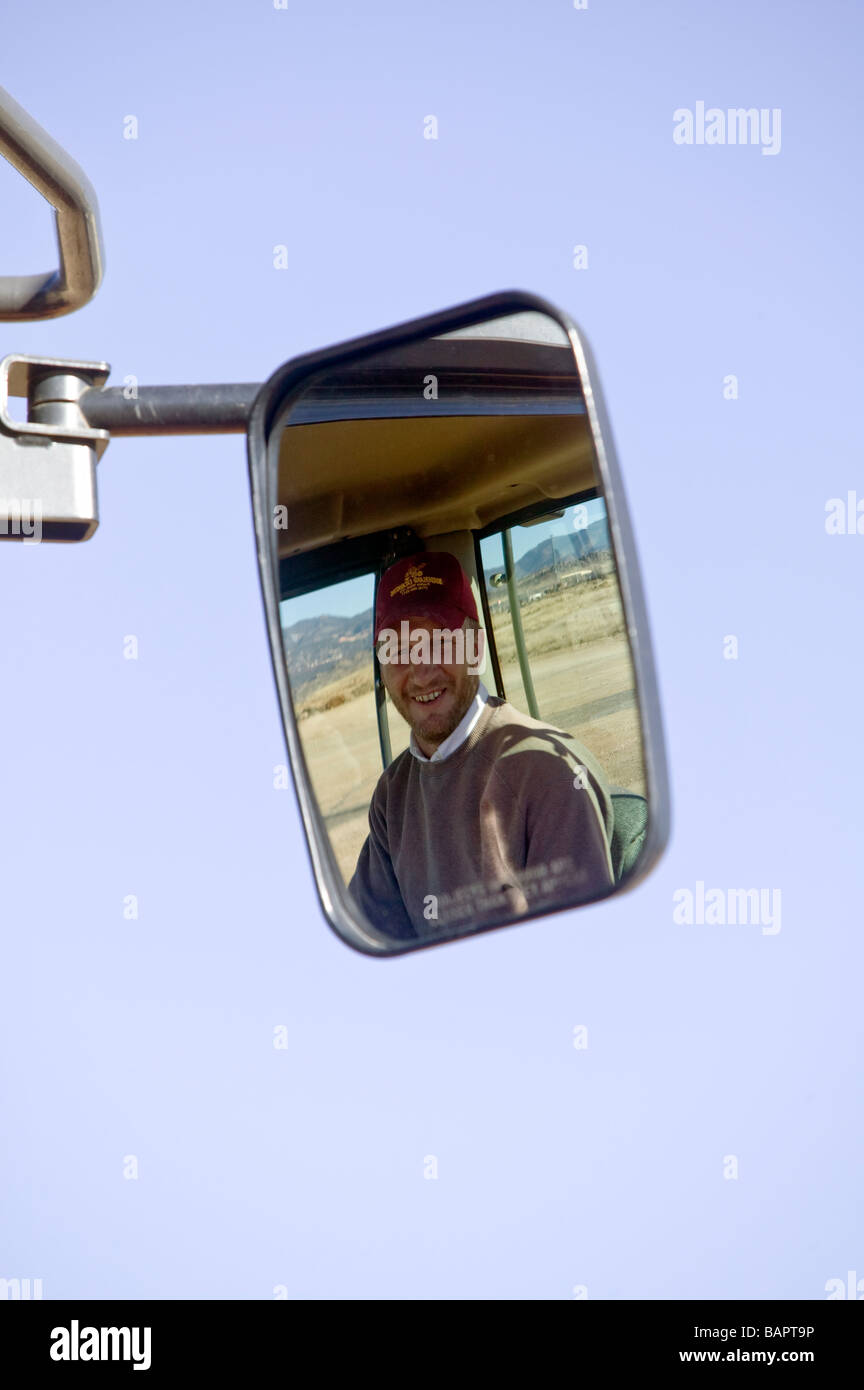 View in the mirror of the operator of a front end loader which is ...