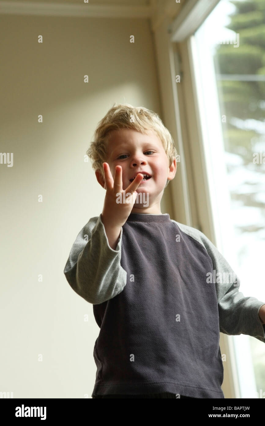 3 year old boy holding up 3 fingers Stock Photo - Alamy